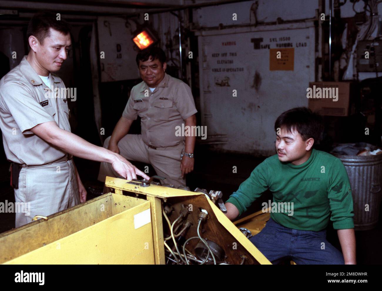 A chief petty officer points out a feature of a NAN-2 nitrogen ...