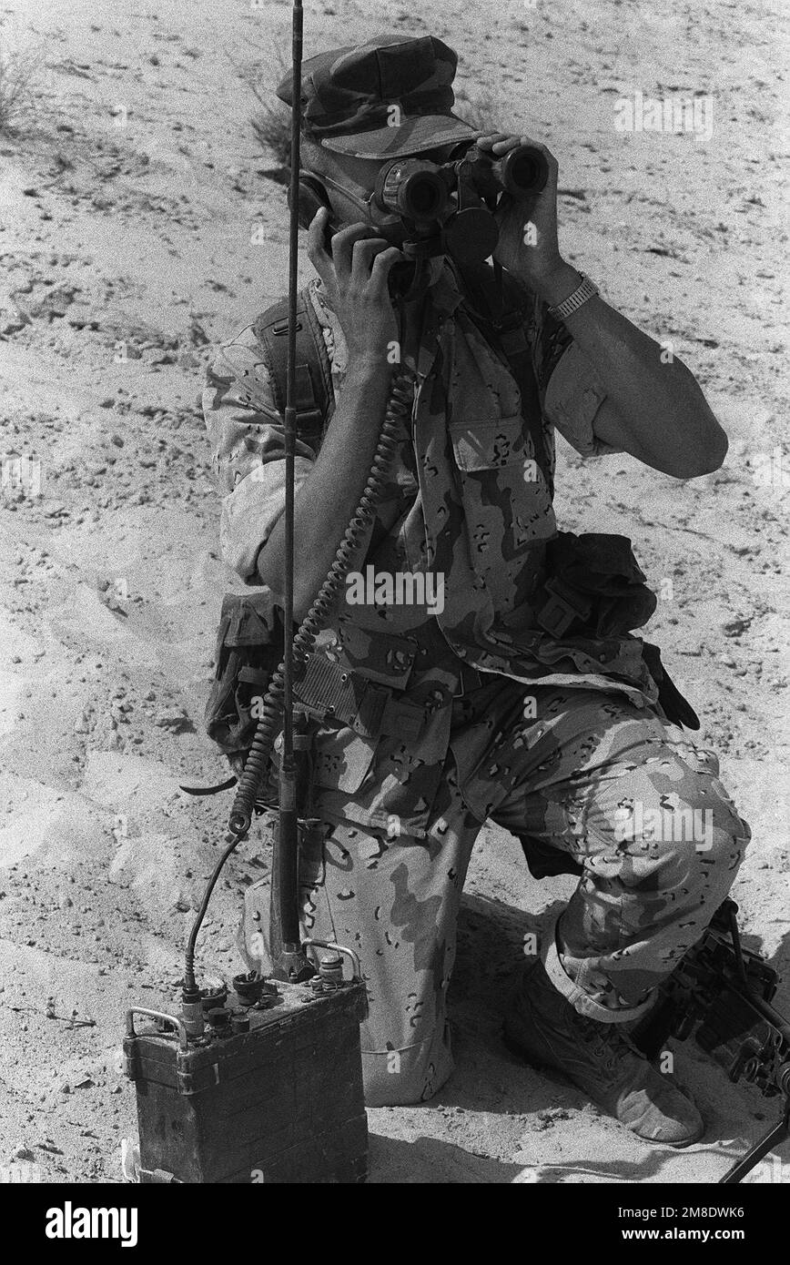 A Marine from 1ST Battalion, 3rd Marines, uses an AN/PRC-77 field radio ...