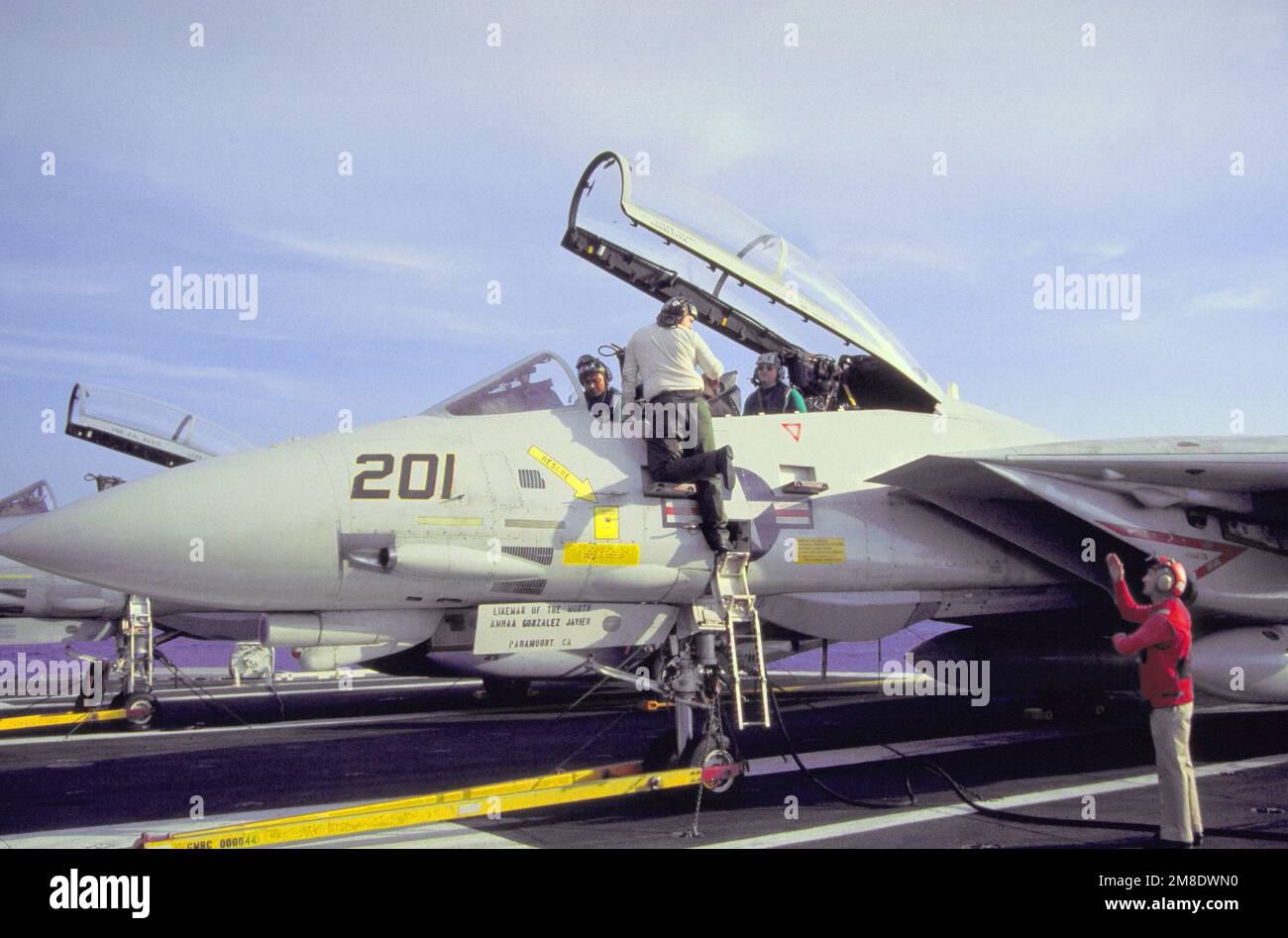 Maintenance crewmen work on a Fighter Squadron 213 (VF-213) F-14A ...