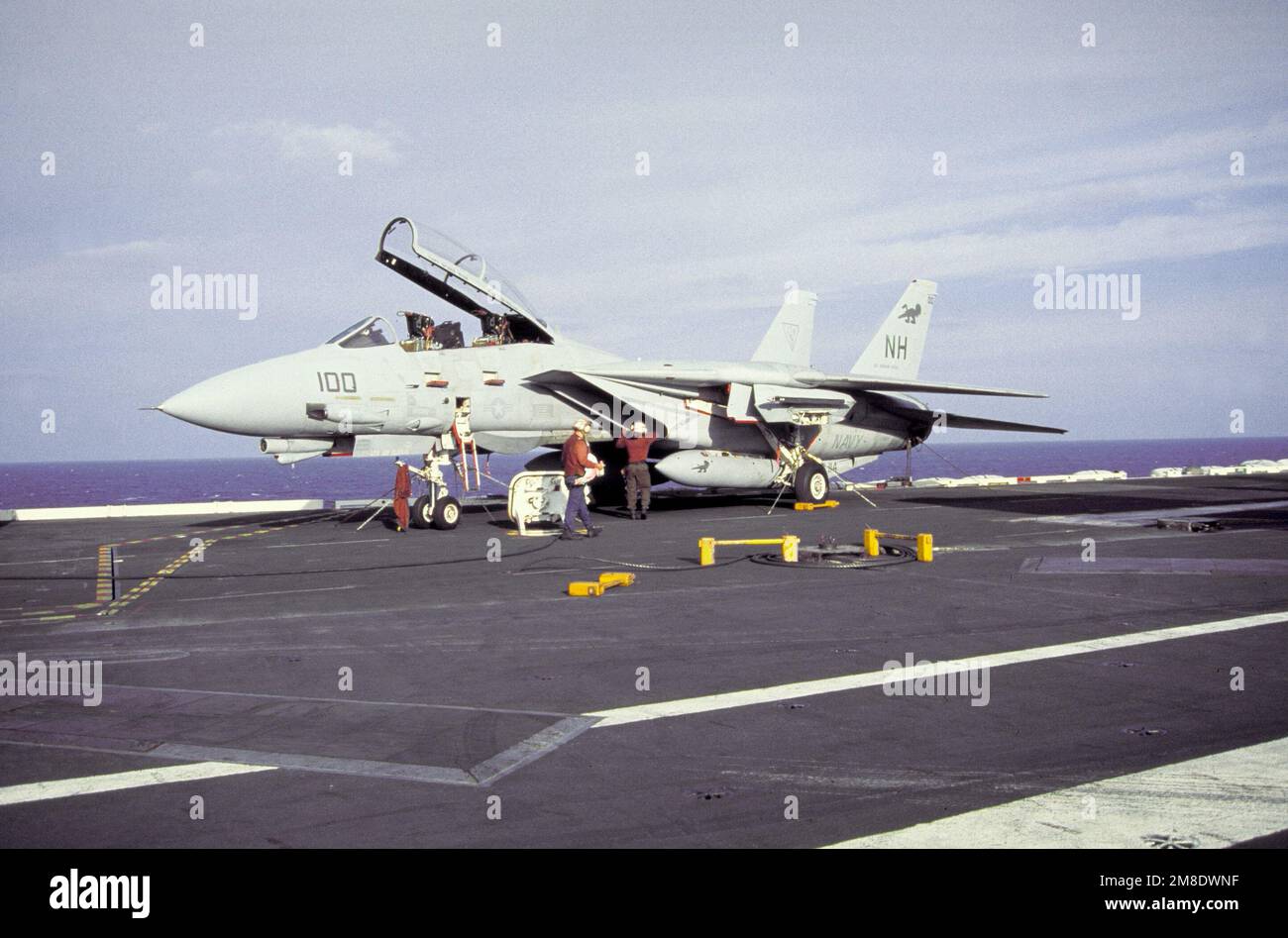 Maintenance crewmen work on a Fighter Squadron 114 (VF-114) F-14A ...