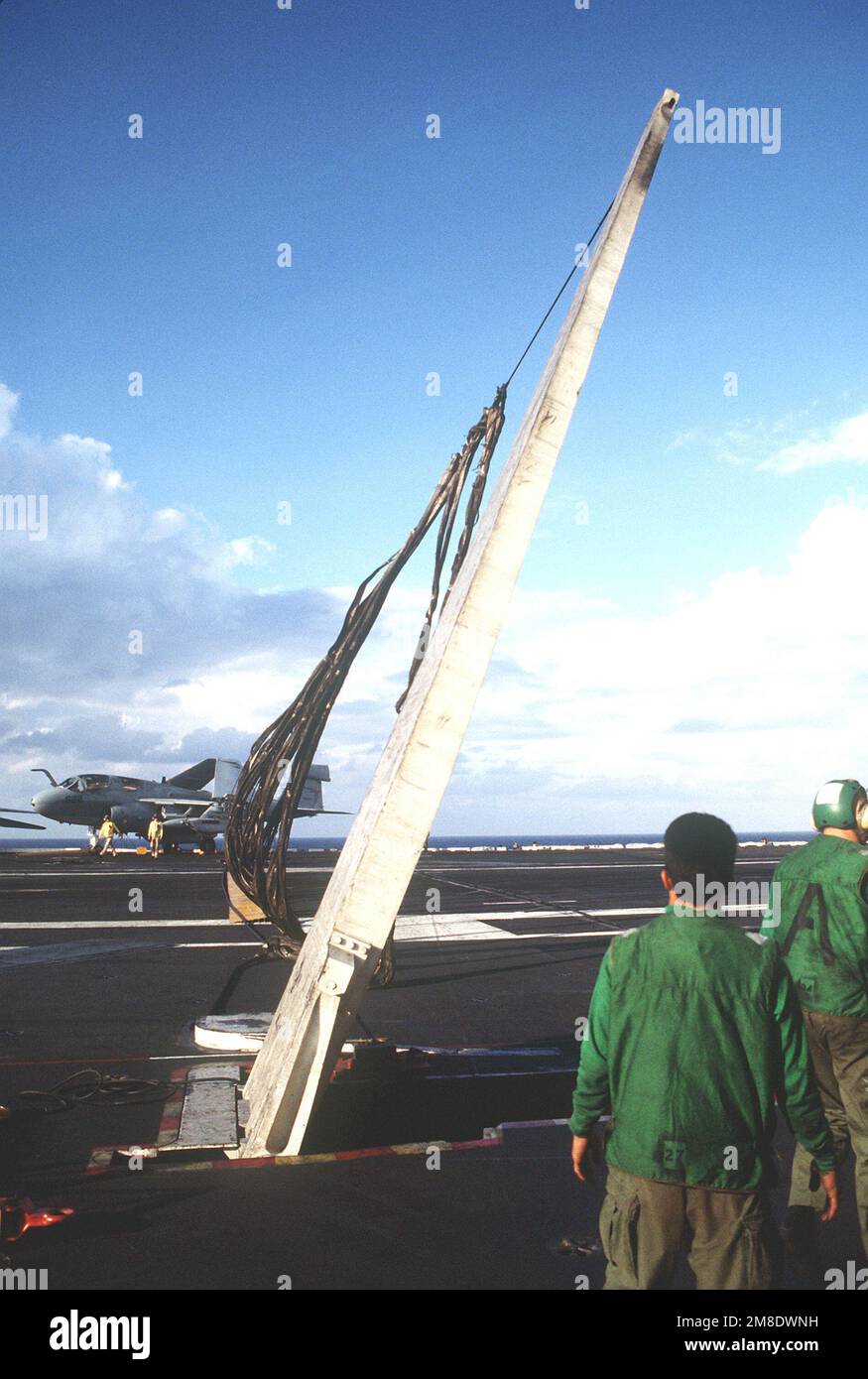 The crash barricade is raised on the flight deck during a drill aboard ...
