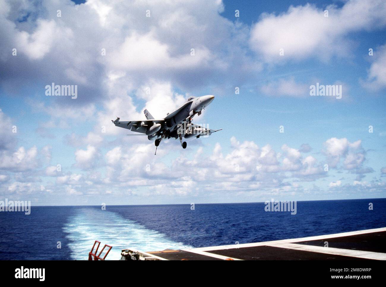 A Strike Fighter Squadron 305 (VFA-305) F/A-18 Hornet aircraft comes in ...