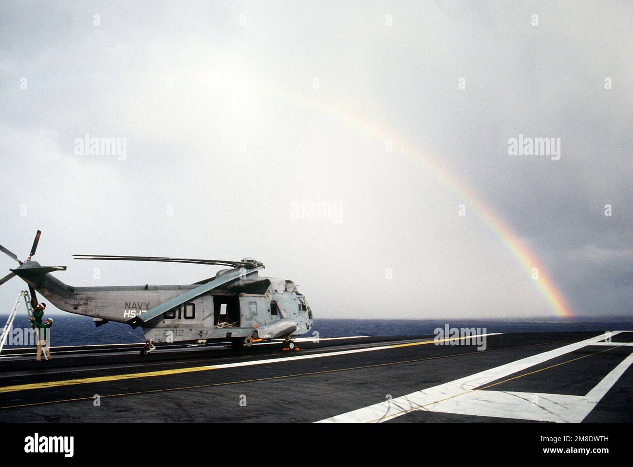 Flight deck crew members work on the tail rotor of a Helicopter Anti ...