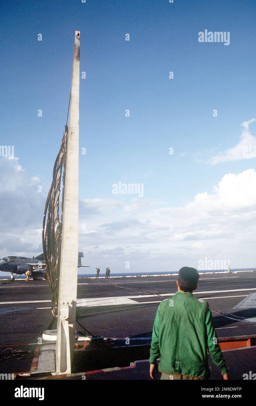 The crash barricade is raised on the flight deck during a drill aboard ...
