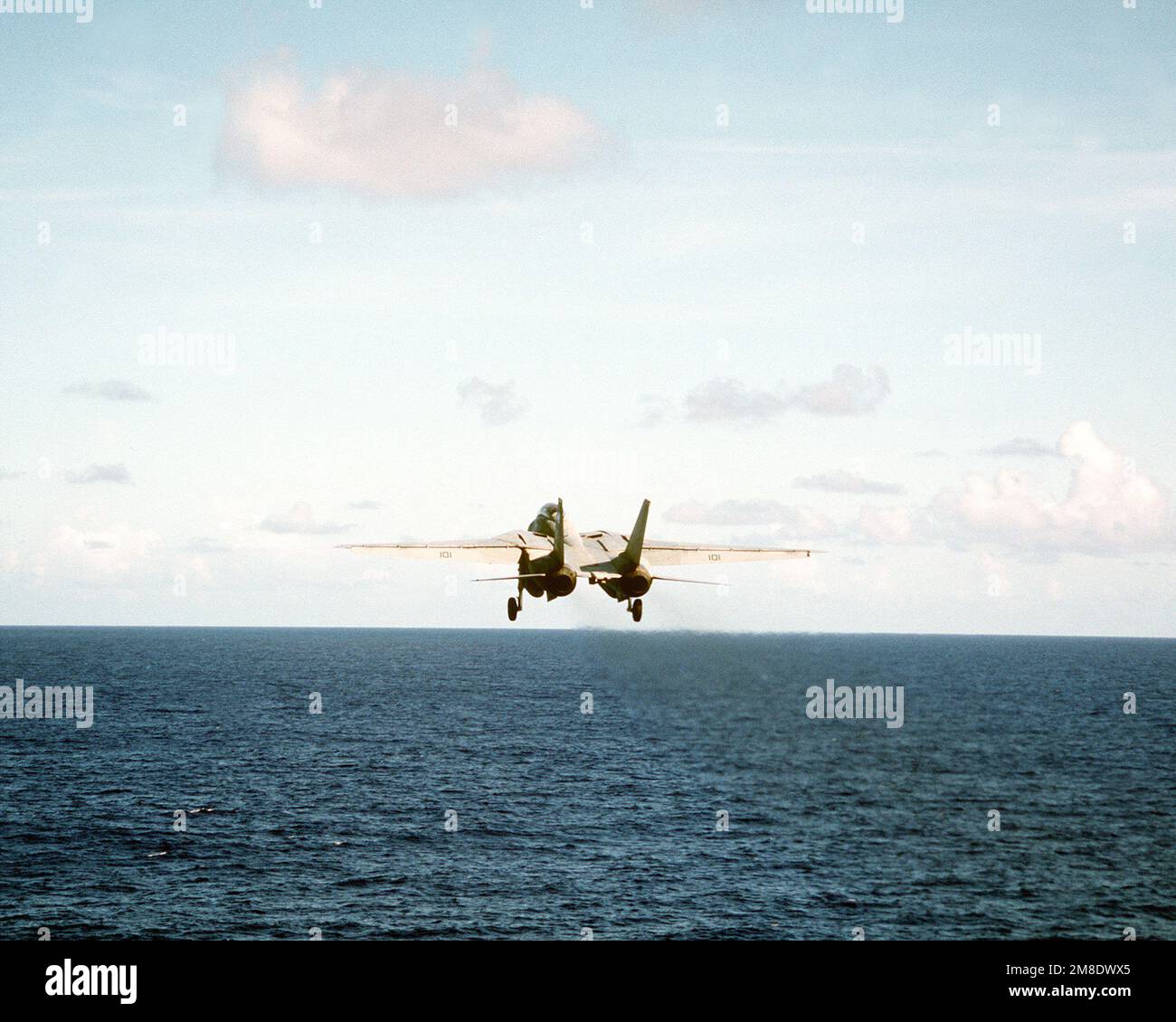 A Fighter Squadron 114 (VF-114) F-14A Tomcat aircraft gains altitude ...