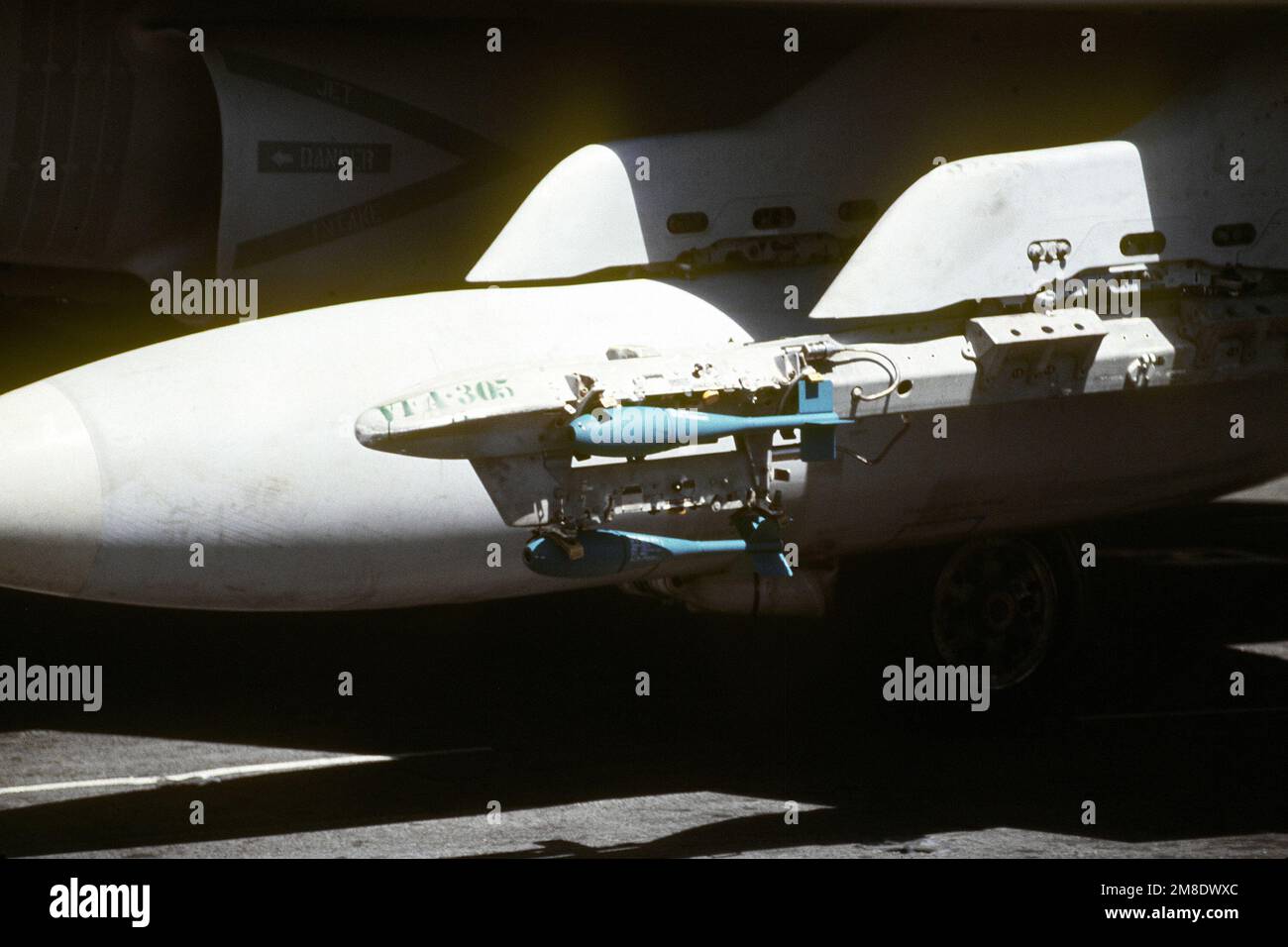 A view of two Mark 76 Mod 5 25-pound practice bombs mounted on a wing ...
