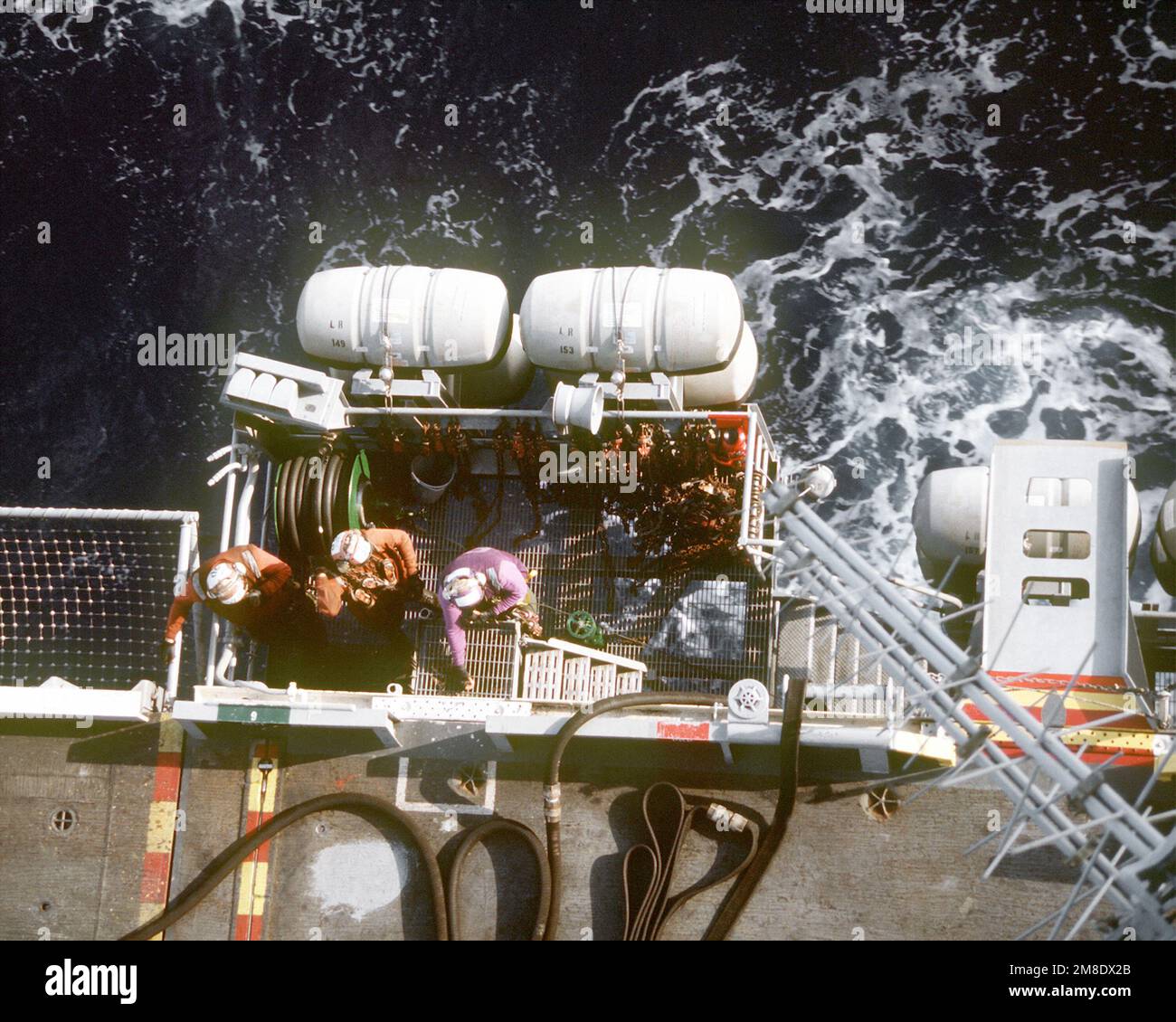 Flight deck crew members stand by at their station aboard the nuclear ...