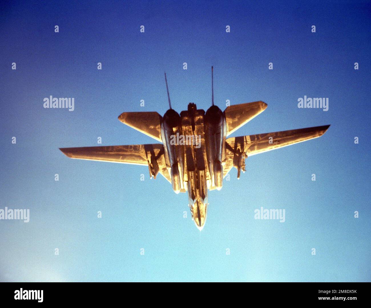 The late afternoon sun is reflected on the underside of a Fighter ...