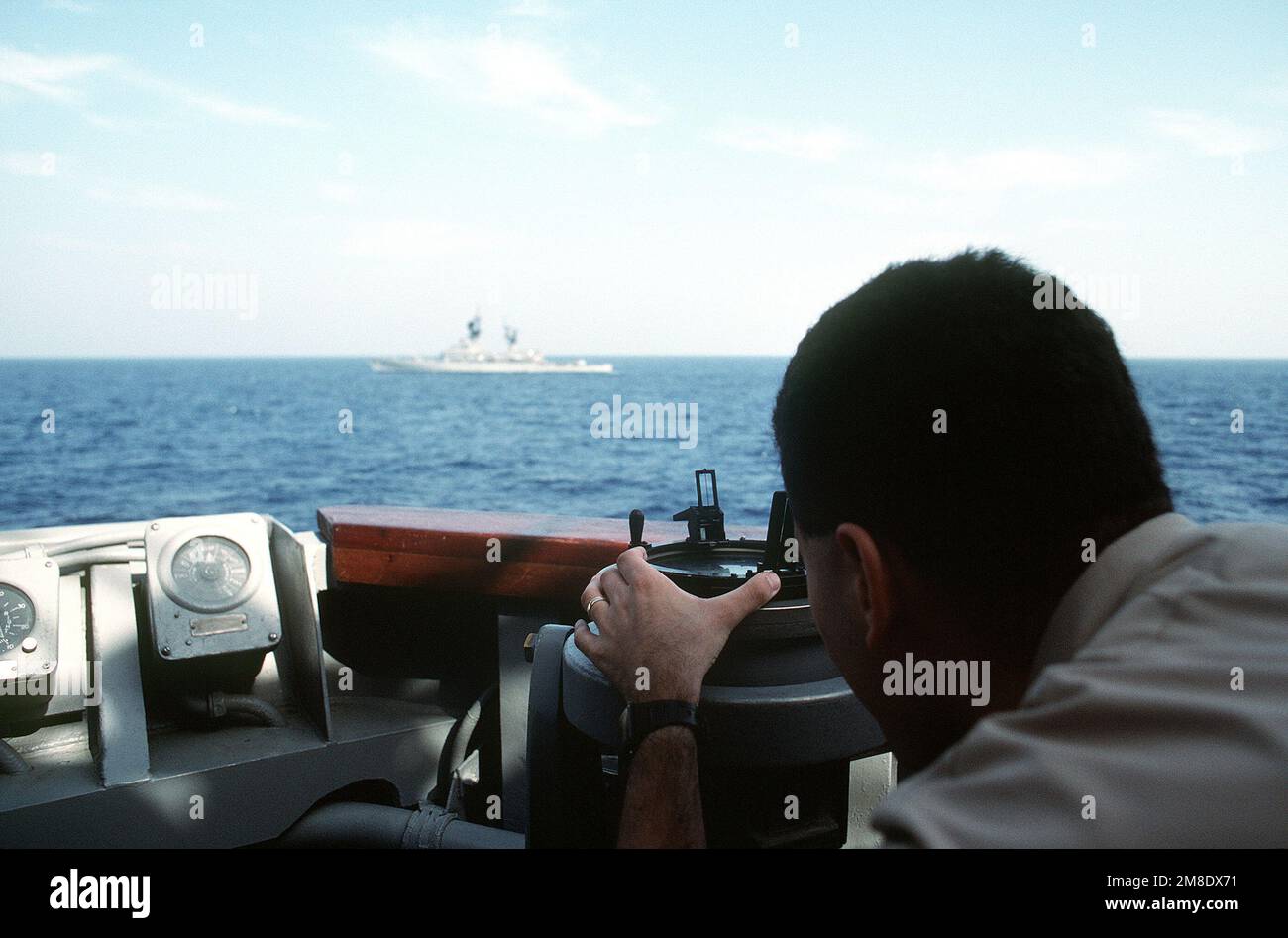 A crew member aboard the nuclear-powered guided missile cruiser USS ...