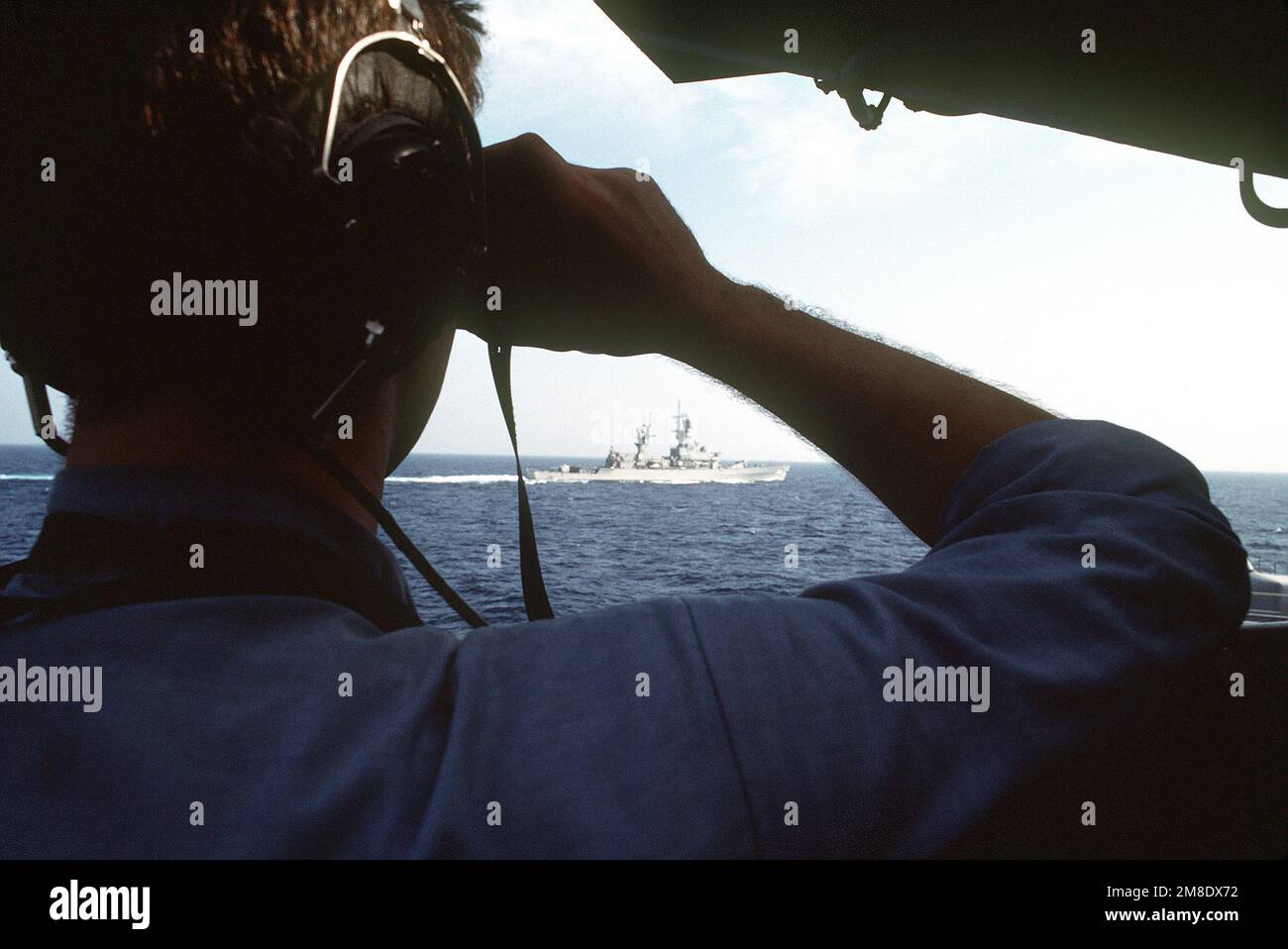 A crew member aboard the nuclear-powered guided missile cruiser USS ...