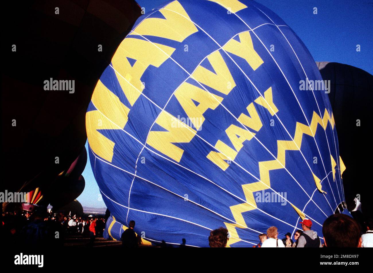 Onlookers gather around a U.S. Navy hot air balloon which is being ...