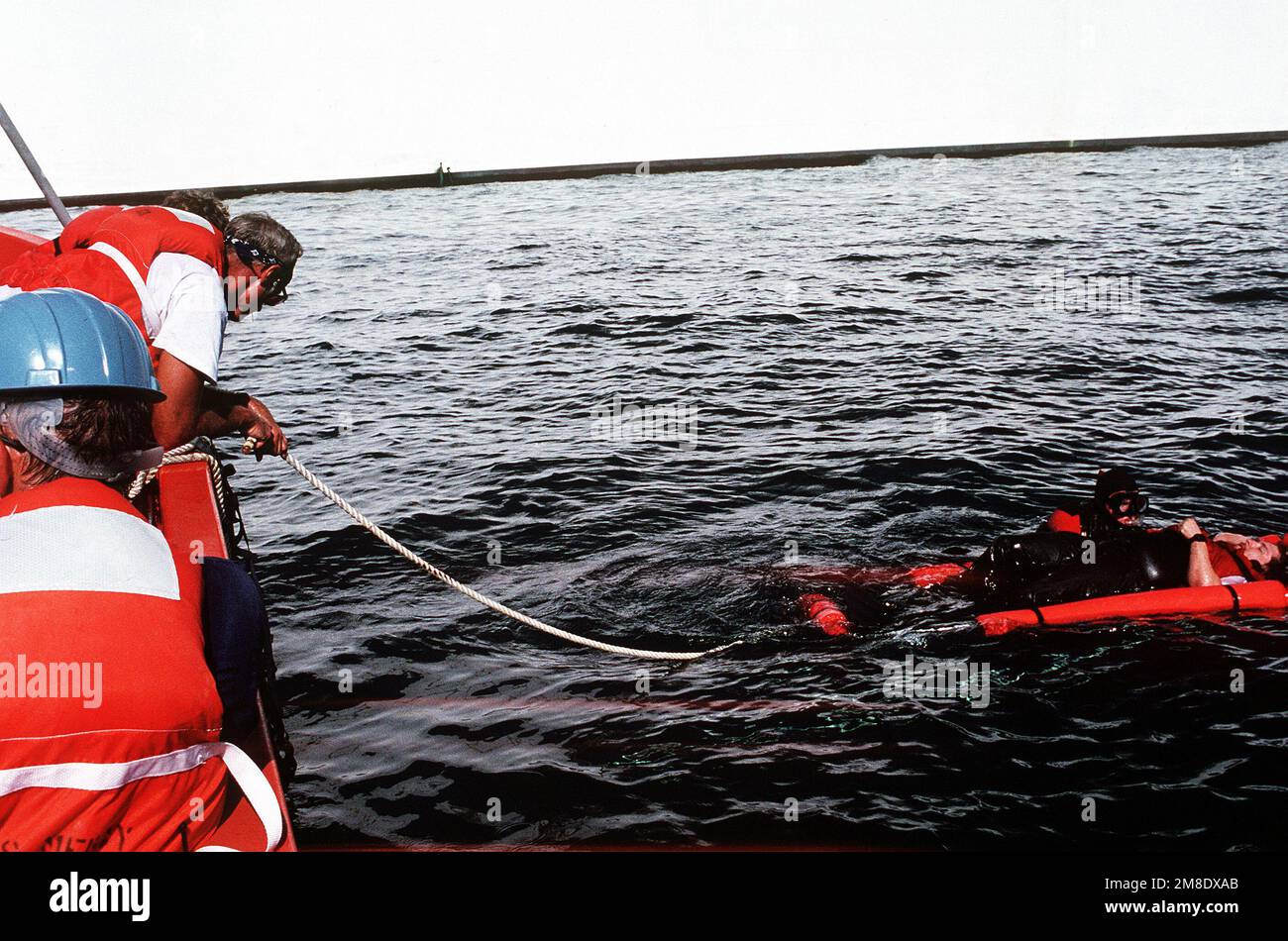 Crew members from the hospital ship USNS MERCY (T-AH-19) rescue a ...