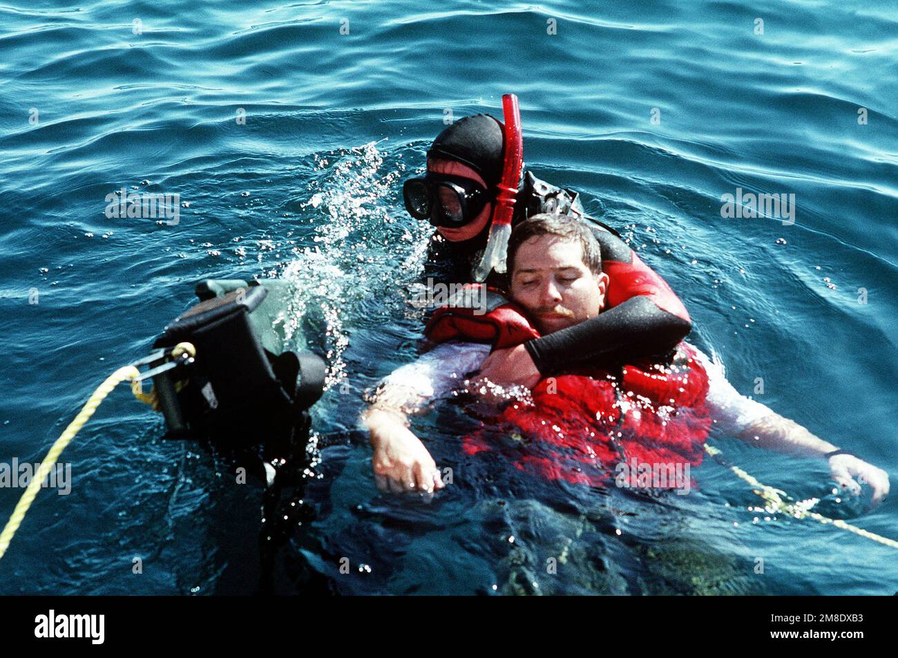 A crew member from the hospital ship USNS MERCY (T-AH-19) rescues a ...
