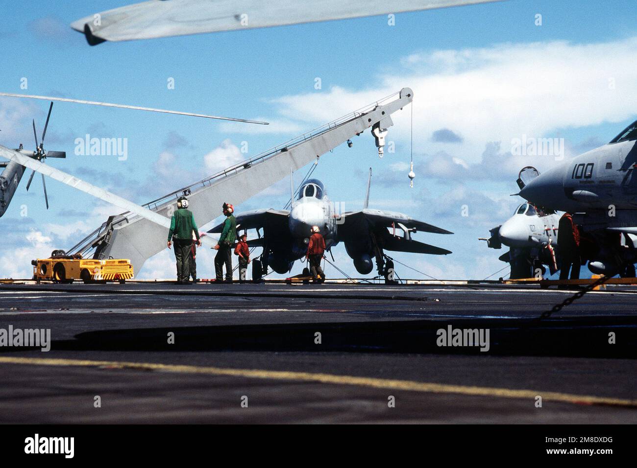 Flight deck crewmen check on a Fighter Squadron 213 (VF-213) F-14A ...