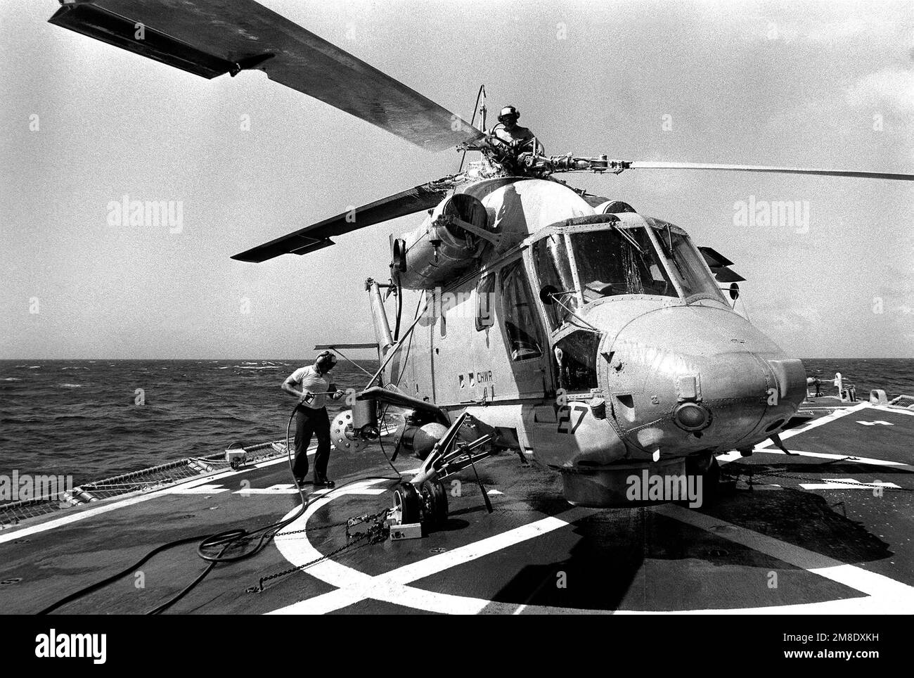 Squadron members clean a Helicopter Light Anti-submarine Squadron 94 ...