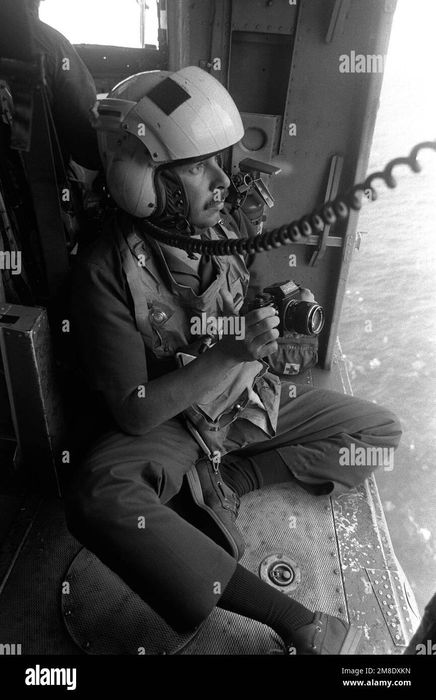 A member of a law enforcement team photographs a drug interdiction ...