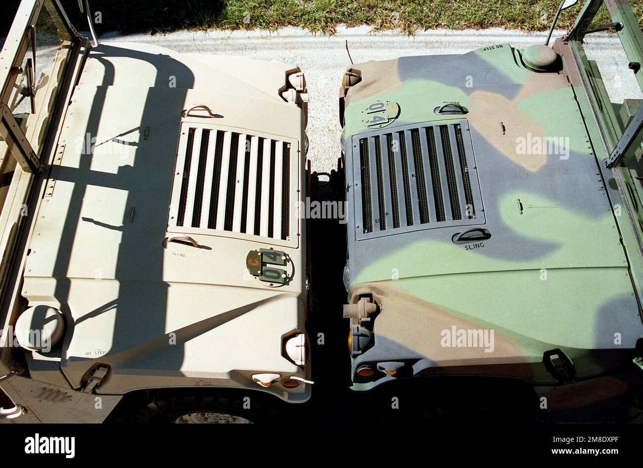 A partial view of two M998 High-Mobility Multipurpose Wheeled Vehicles ...