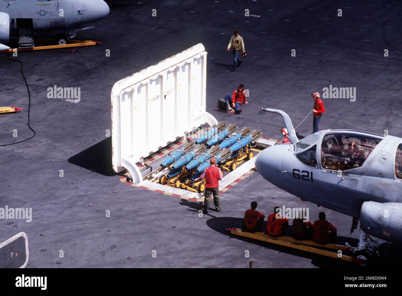 Aviation ordnancemen stand by to remove Aero 21A weapons skids loaded ...