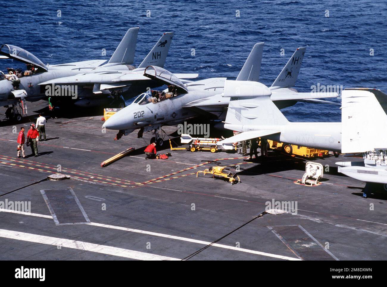 Maintenance personnel work on F-14A Tomcat aircraft from Fighter ...