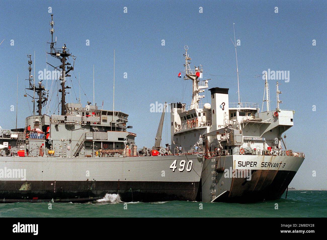 The ocean minesweeper USS LEADER (MSO-490) stands on the partially ...