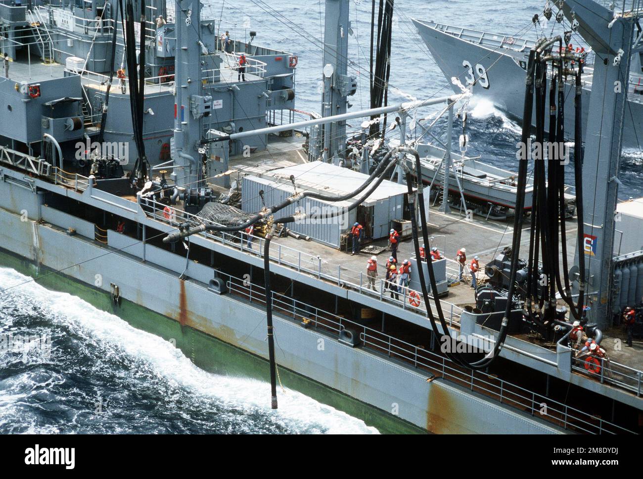 A refueling hose is retracted following underway replenishment ...