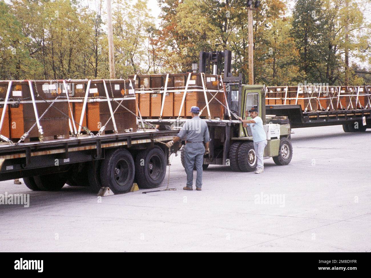 Ammunition operations personnel load trailers with containers of 30mm ...
