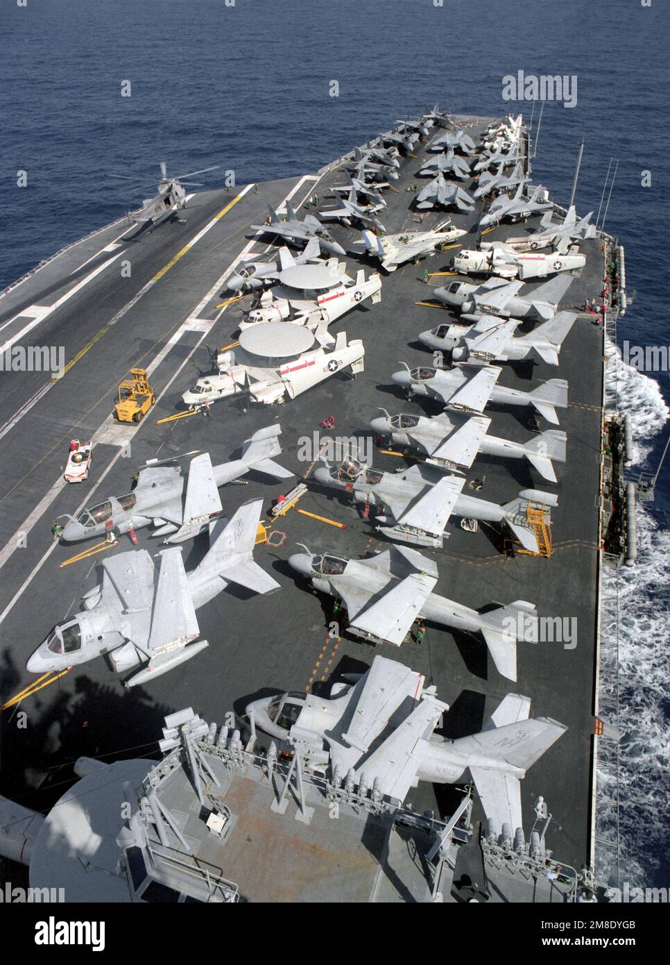 Various aircraft line the flight deck of the nuclear-powered aircraft ...