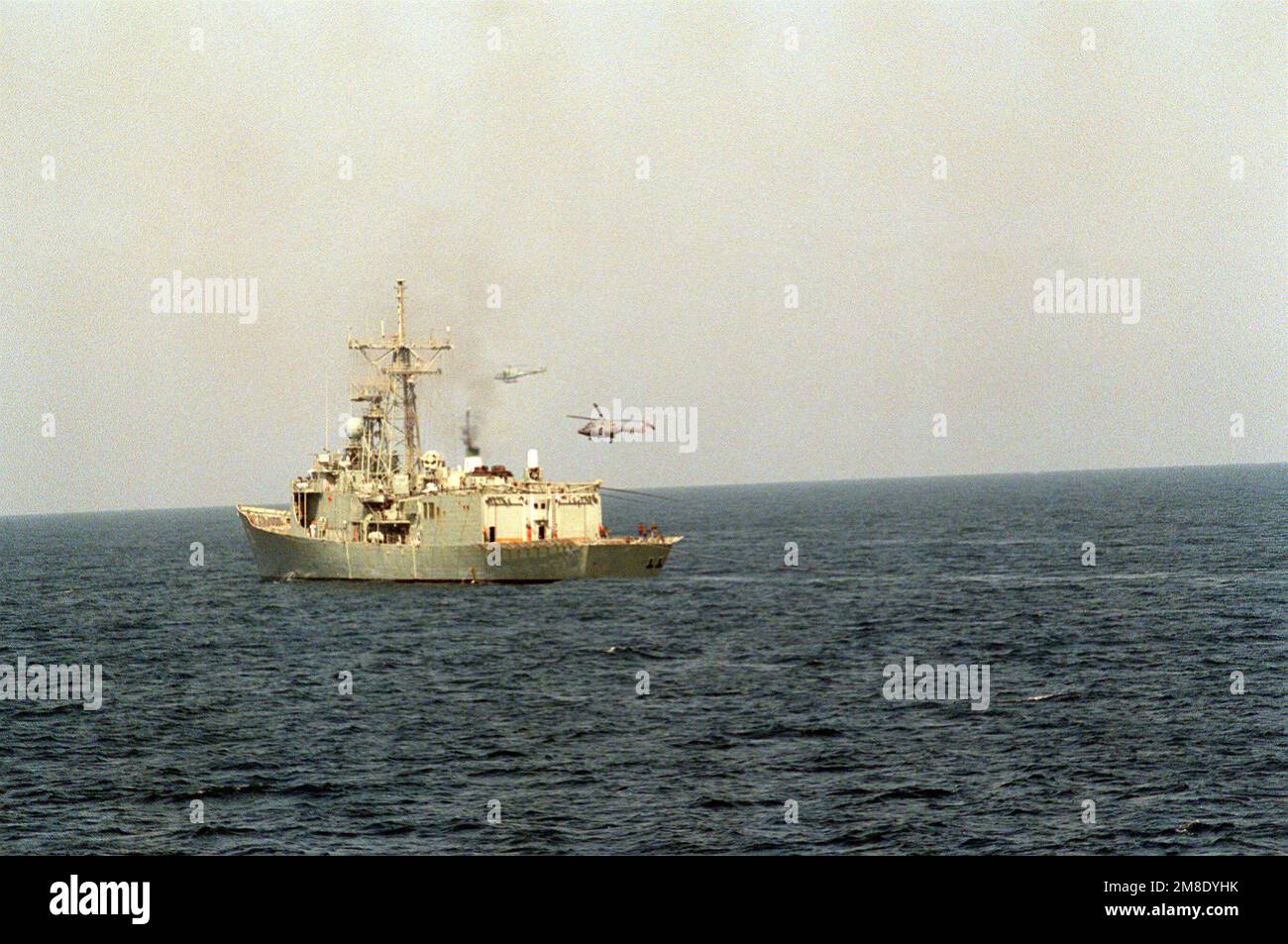 A SA-330 Puma helicopter flies over the fantail of the Australian ...