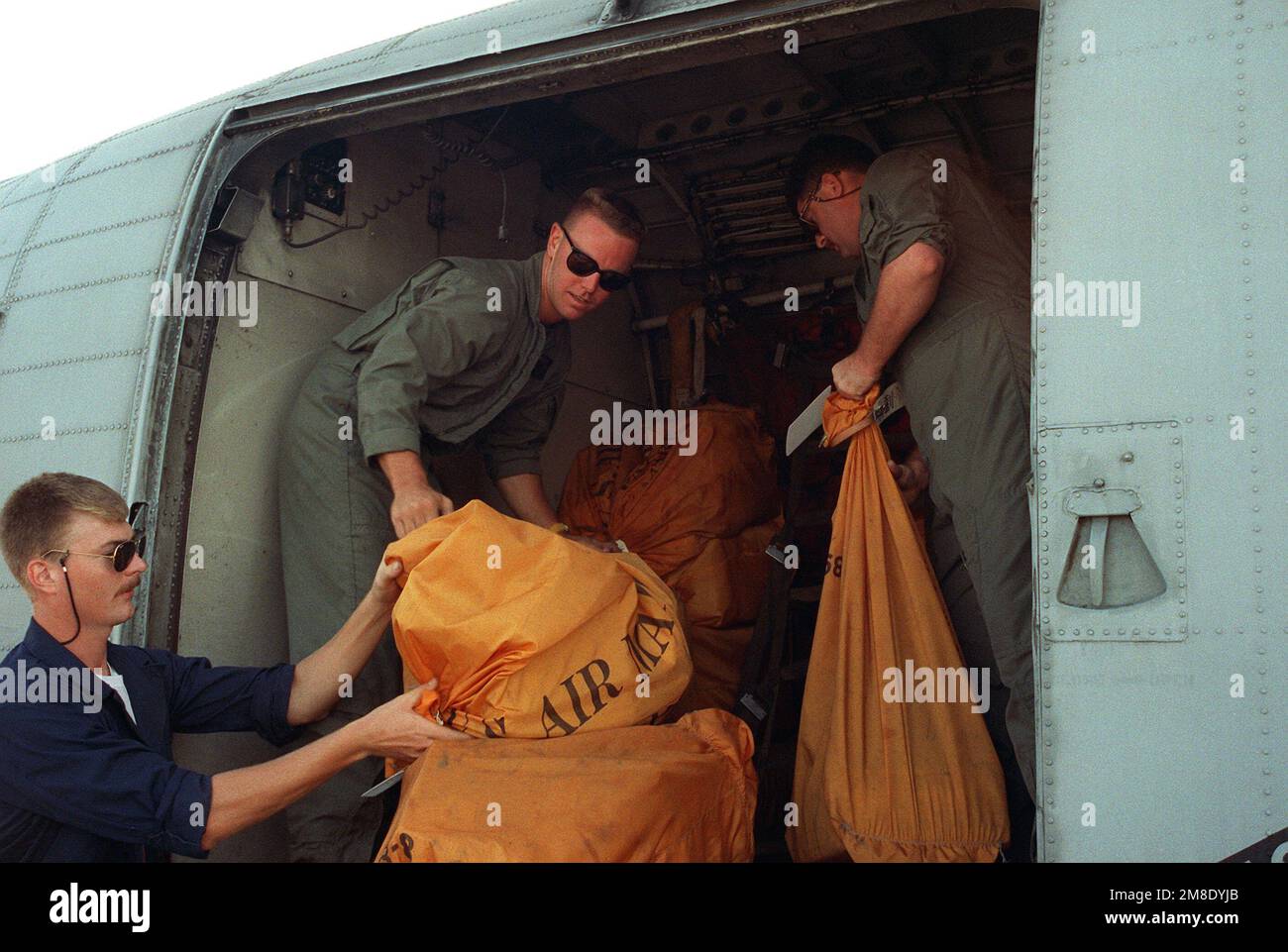 Sacks of mail are loaded aboard a Detachment 2, Helicopter Combat ...
