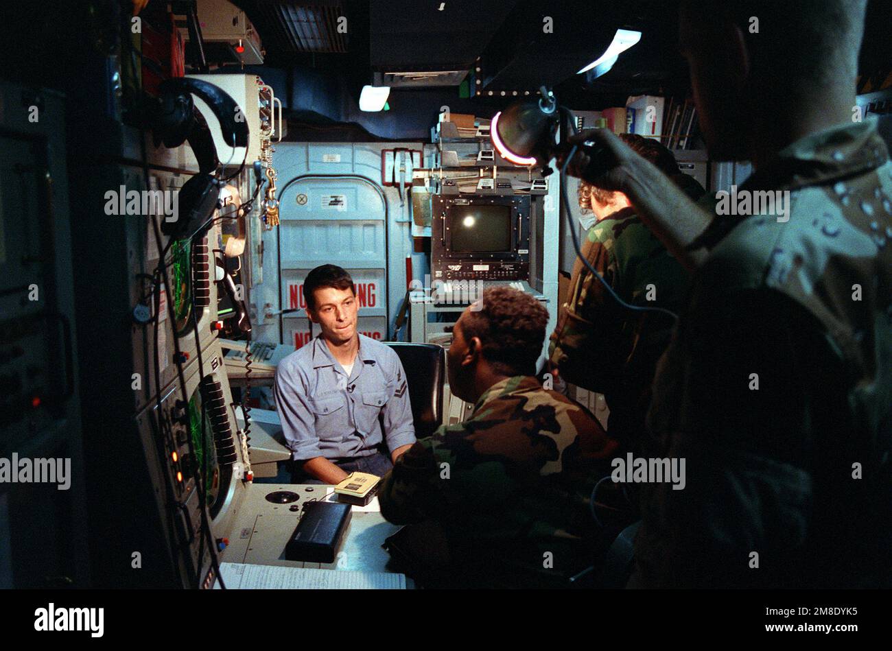 Journalist 2nd Class Quinn Lyton, center, interviews a sonar technician ...
