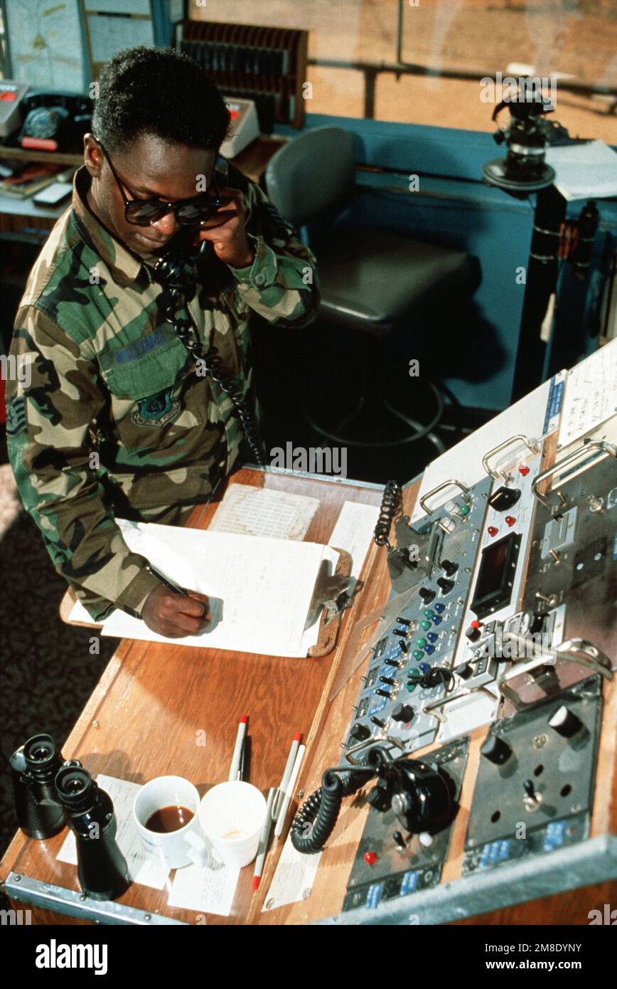 An Air Force staff sergeant communicates with the pilot of an incoming ...
