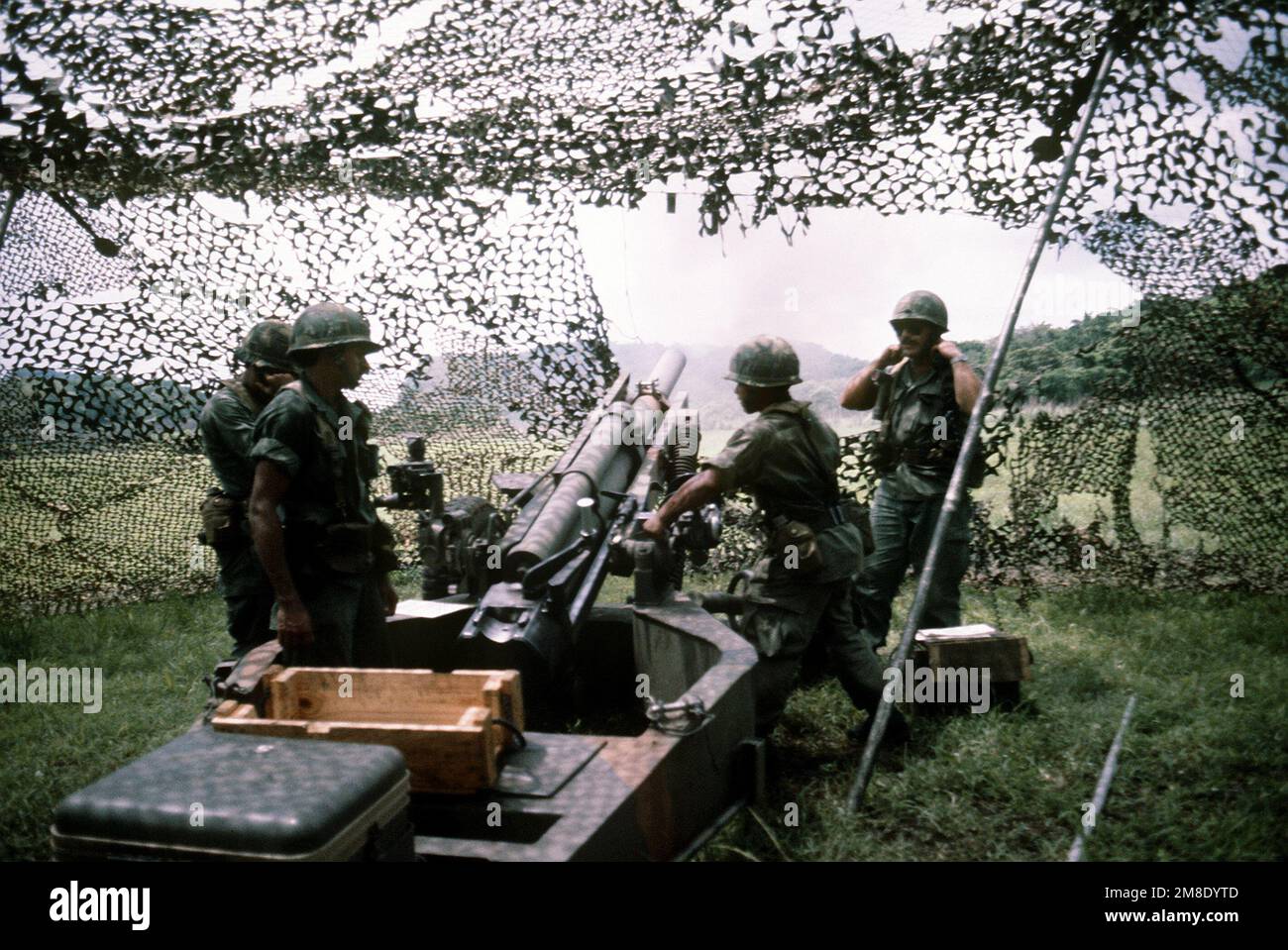 Soldiers fire an M-102 105mm howitzer during gunnery practice at Empire Range. Country: Panama ...