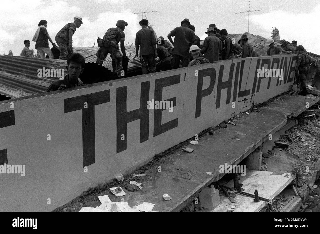 Rescue workers, assisted by members of a United States Marine ...