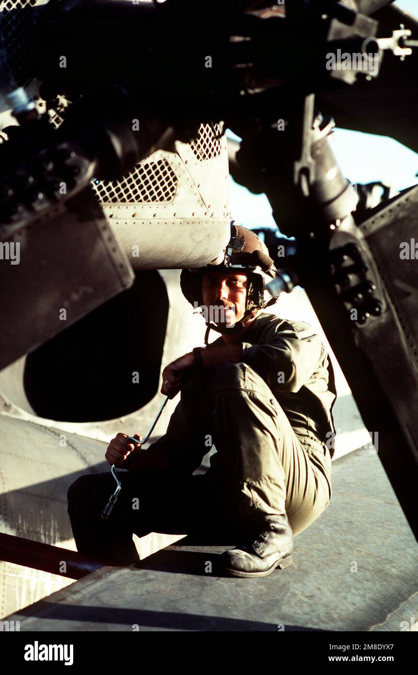 A member of Marine Heavy Helicopter Squadron 464 (HMH-464) sits on one ...