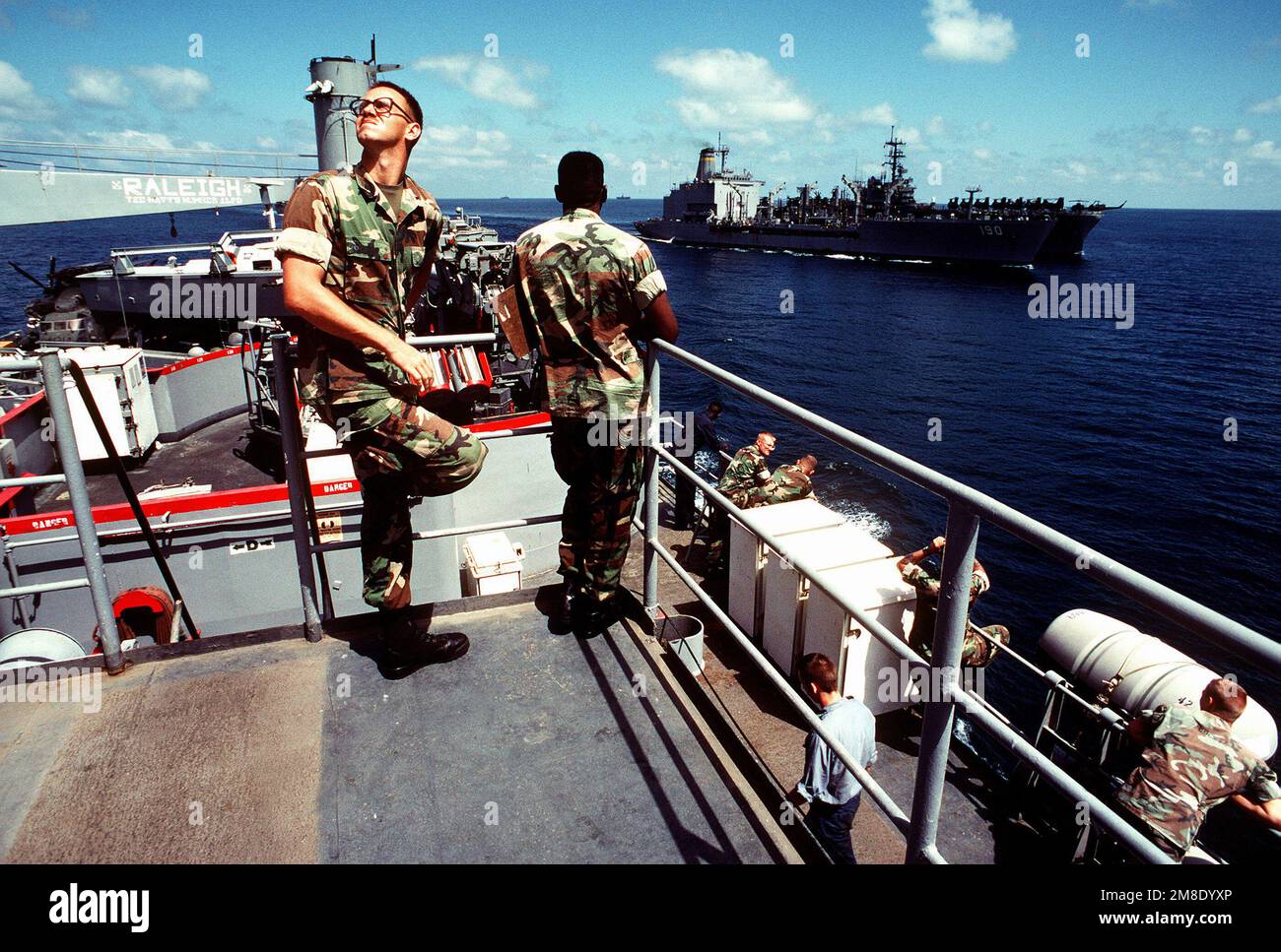 Marines and sailors aboard the amphibious transport dock USS RALEIGH ...
