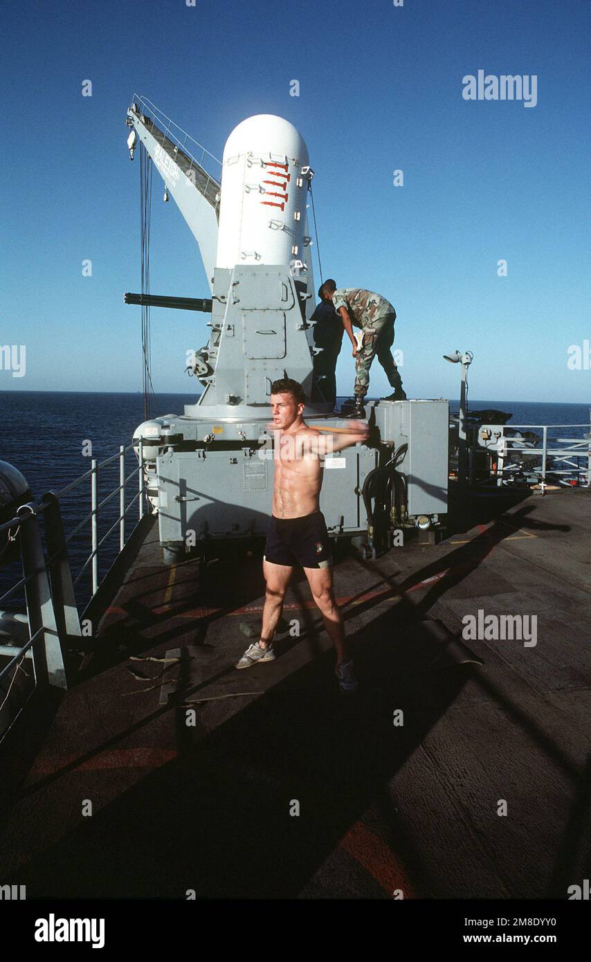 A Marine exercises near a Mark 15 Phalanx Close-In Weapon System (CIWS ...