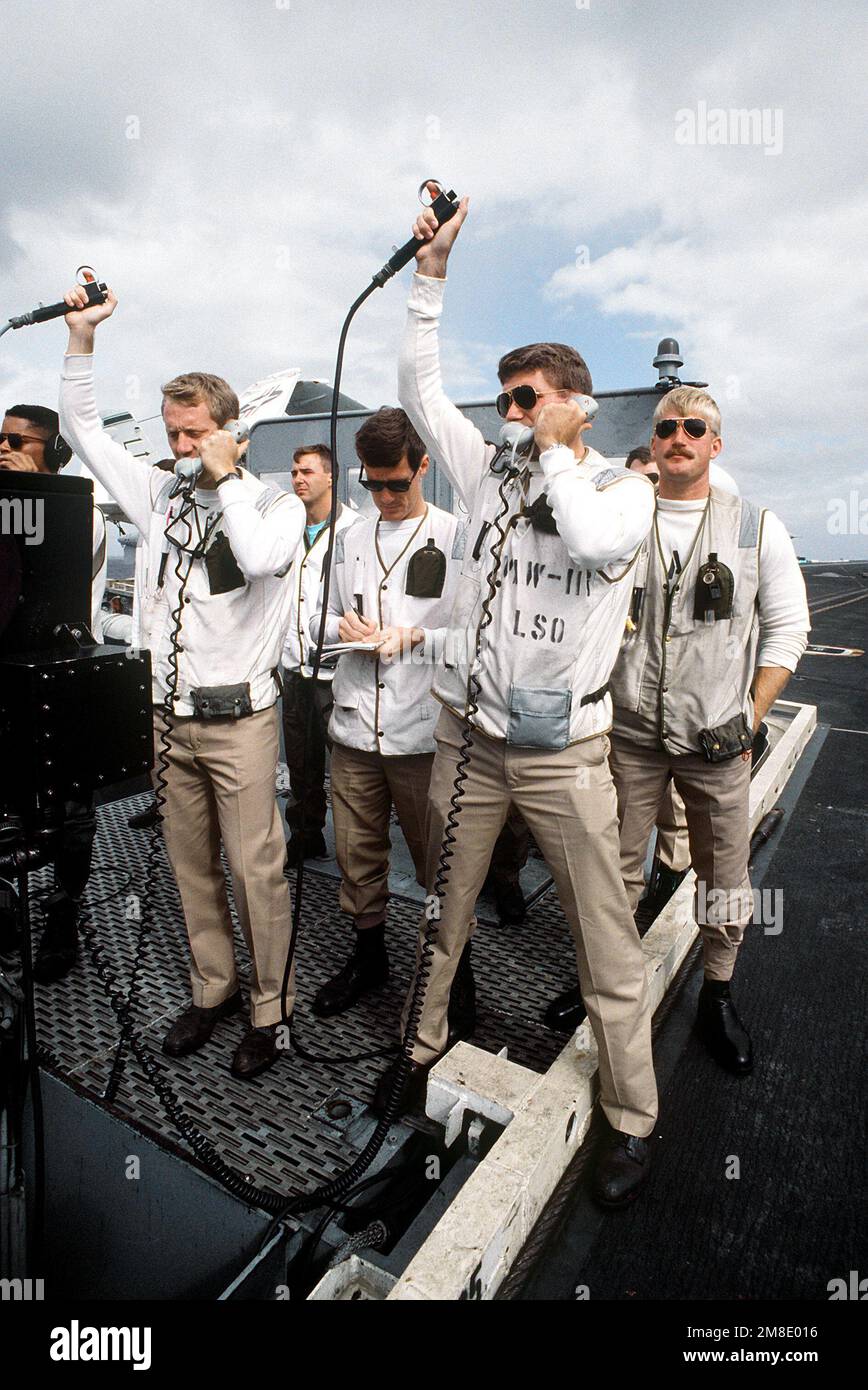 Landing signal officers use pickle switches as they guide incoming ...