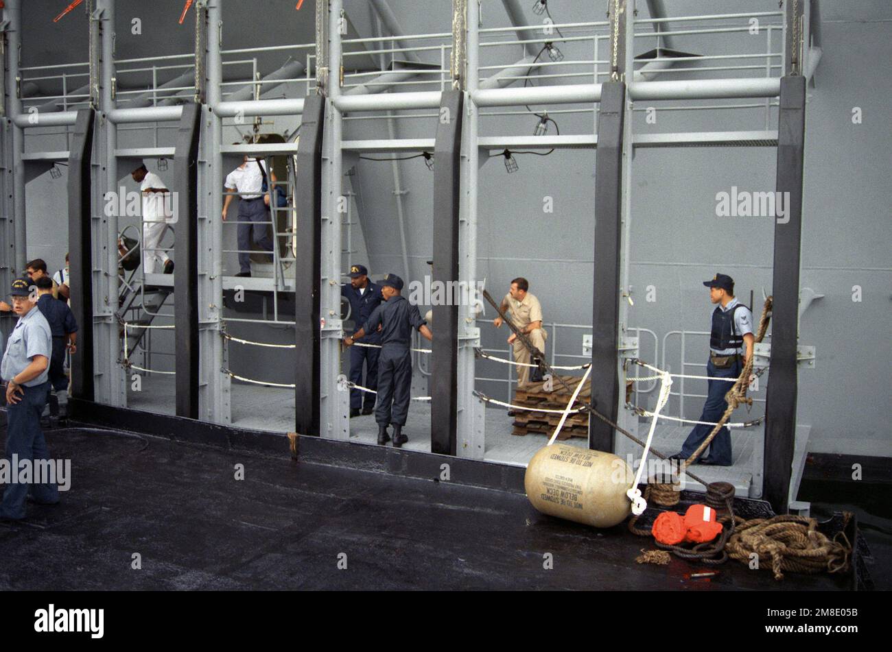 Crew members aboard the nuclear-powered aircraft carrier USS ABRAHAM ...