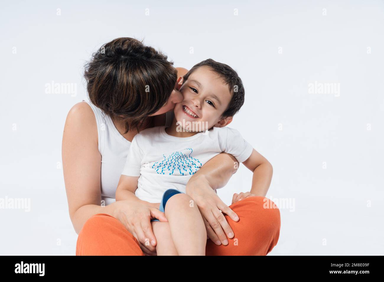 Mom hugs and kisses her little son. Mother's day, family concept - On white background Stock ...