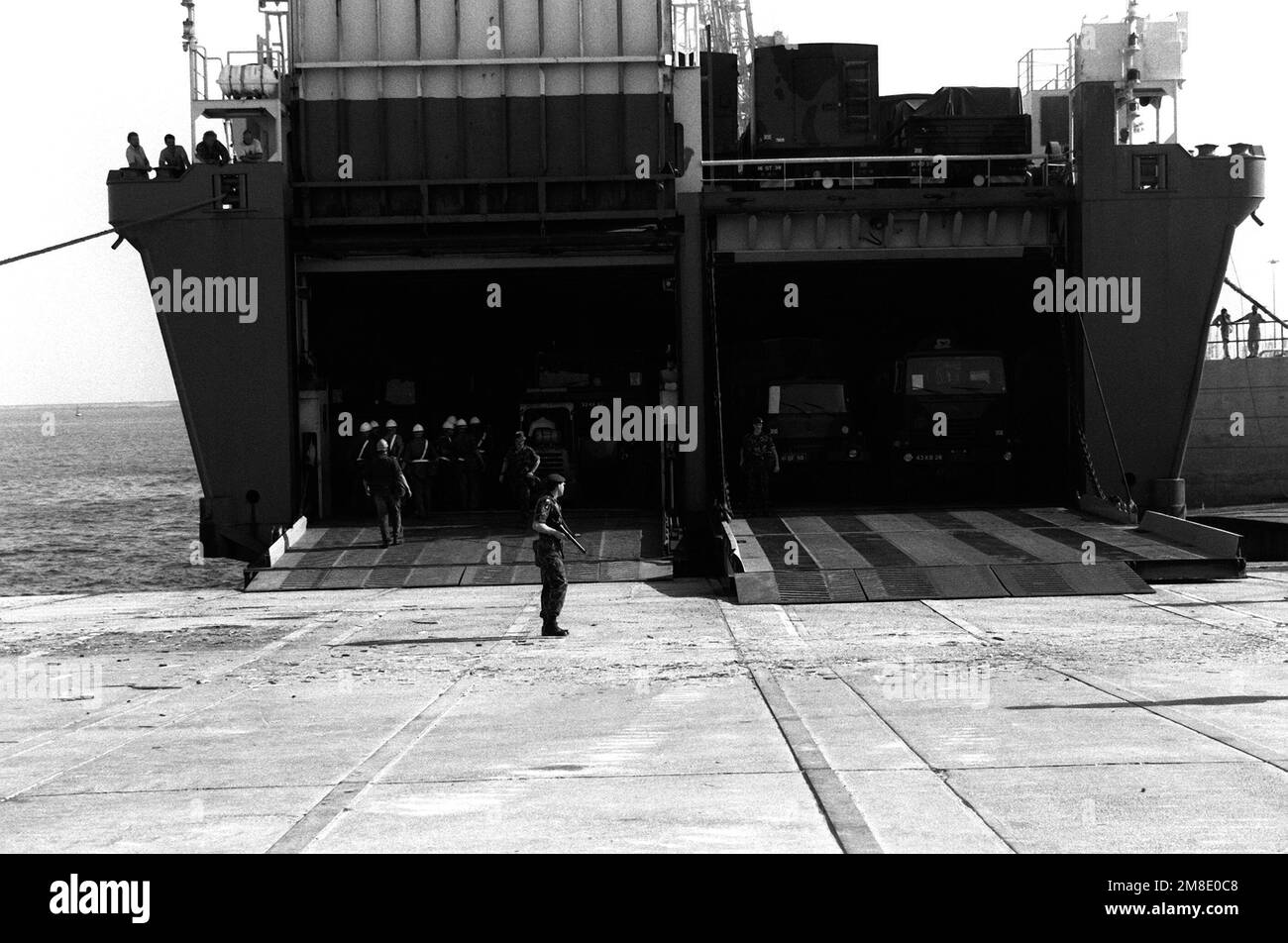 British soldiers go aboard the Danish cargo ship Dana Cimbria to unload ...