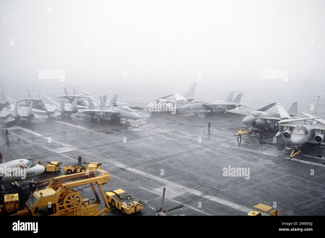 Fog envelops the flight deck of the nuclear-powered aircraft carrier ...