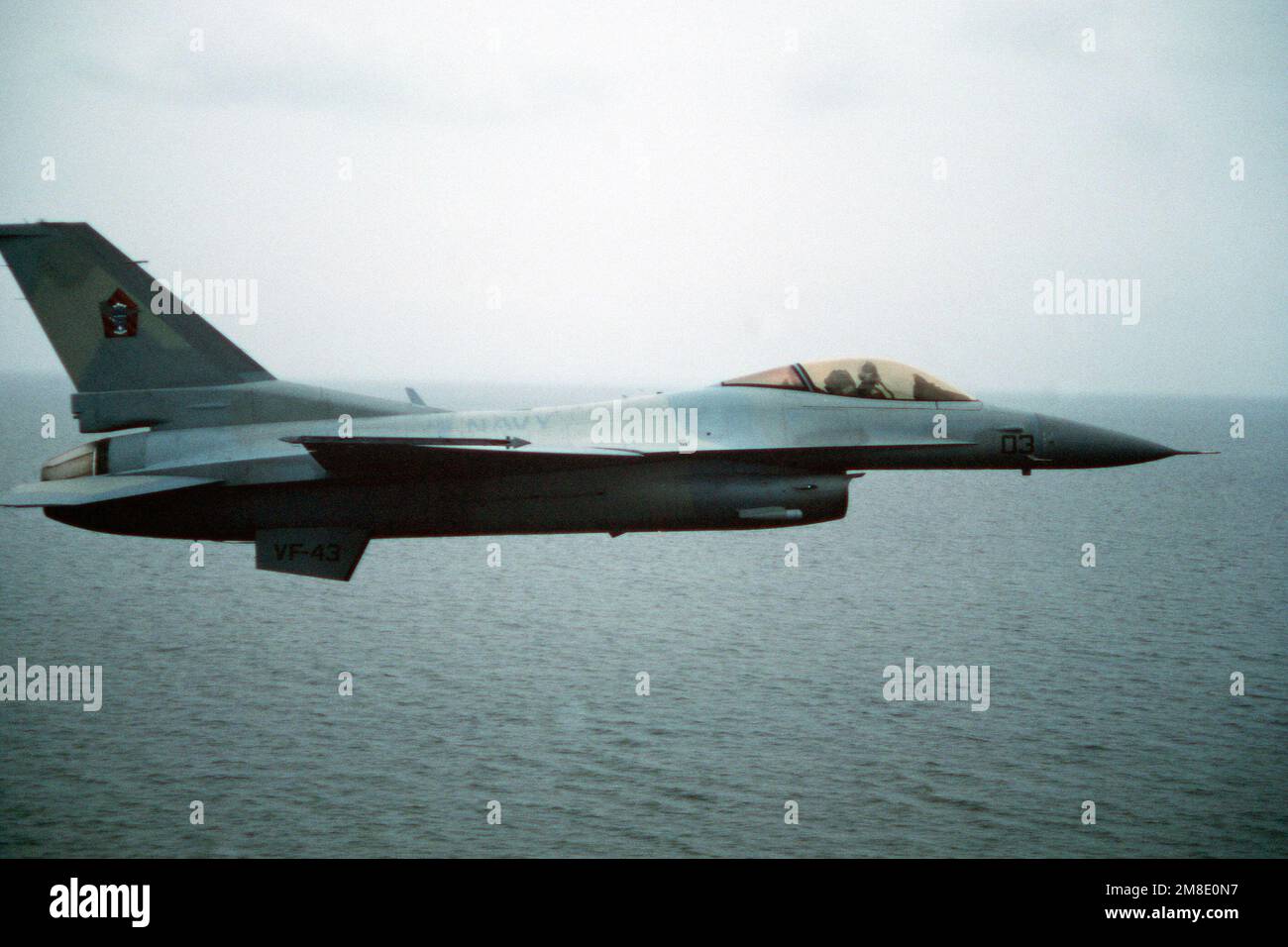 An air-to-air right side view of a Fighter Squadron 43 (VF-43) F-16N ...