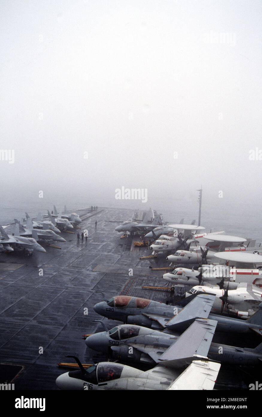 Fog envelops the flight deck of the nuclear-powered aircraft carrier ...