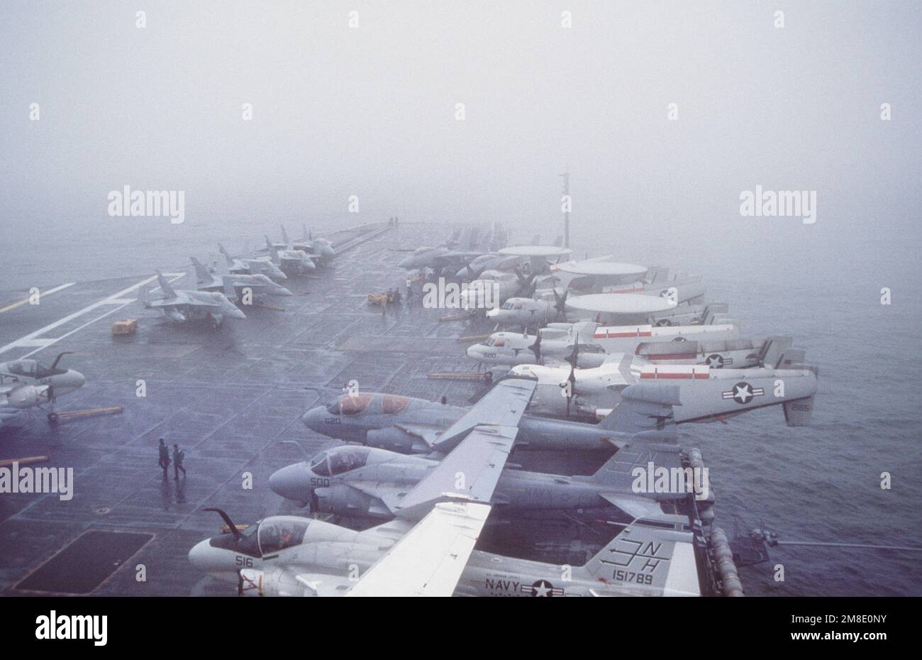 Fog envelops the flight deck of the nuclear-powered aircraft carrier ...