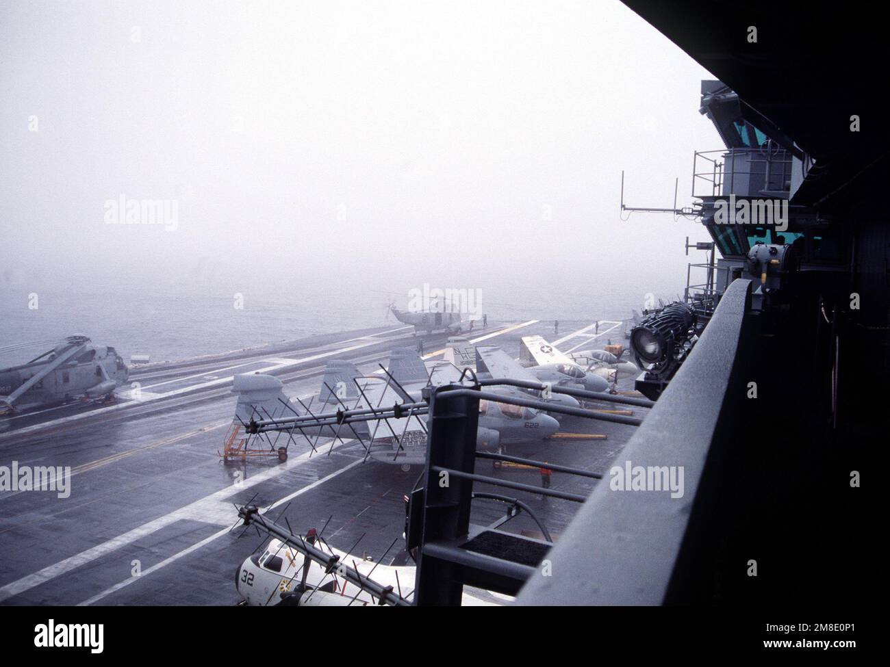 Fog envelops the flight deck of the nuclear-powered aircraft carrier ...