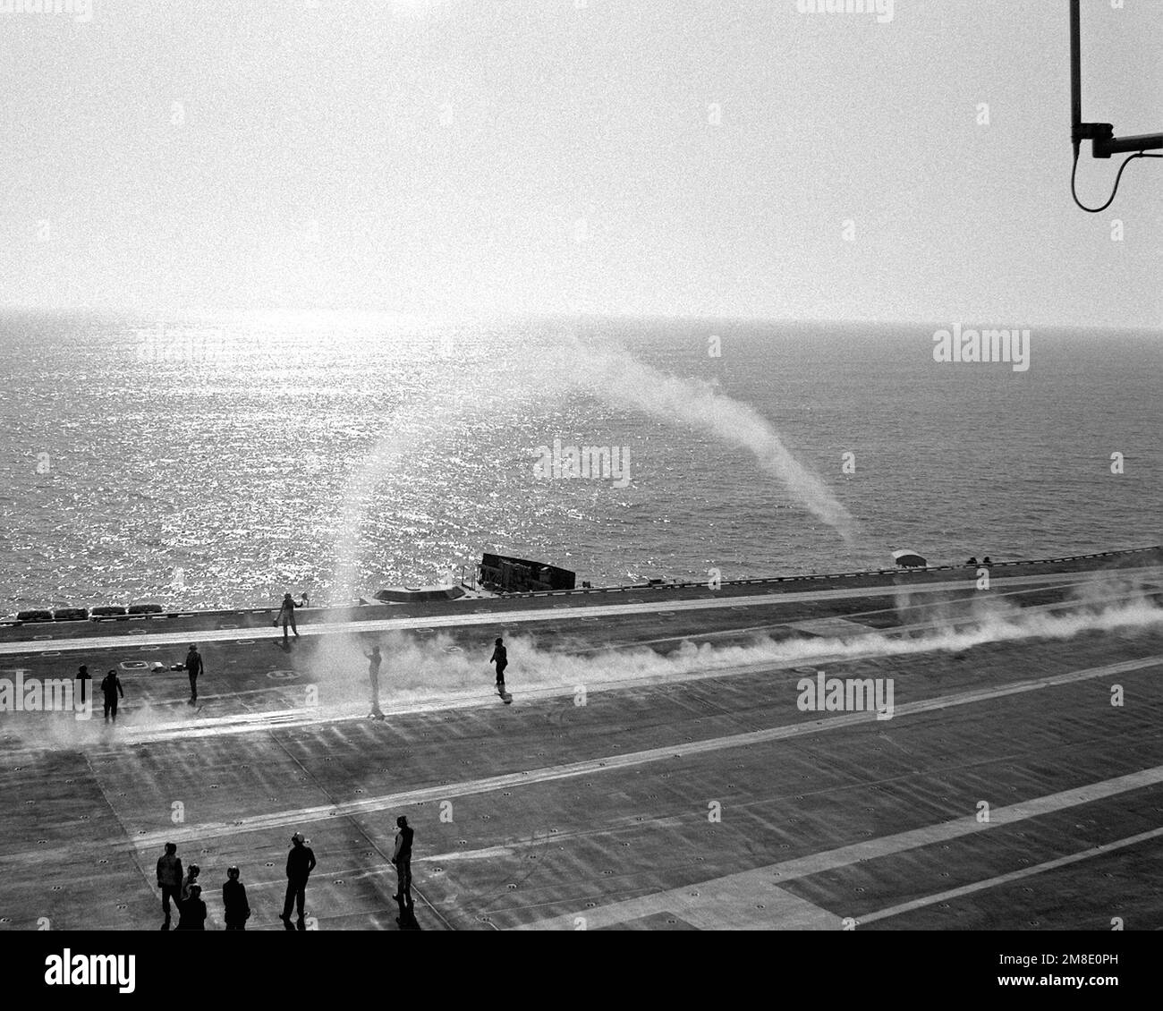 Wind causes vapor from the No. 3 catapult to form an arch following the ...