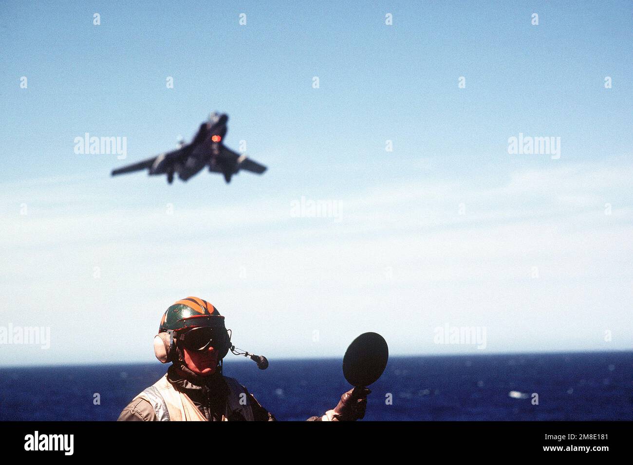 A landing signal officer (LSO) of Fighter Squadron 213 (VF-213) uses ...