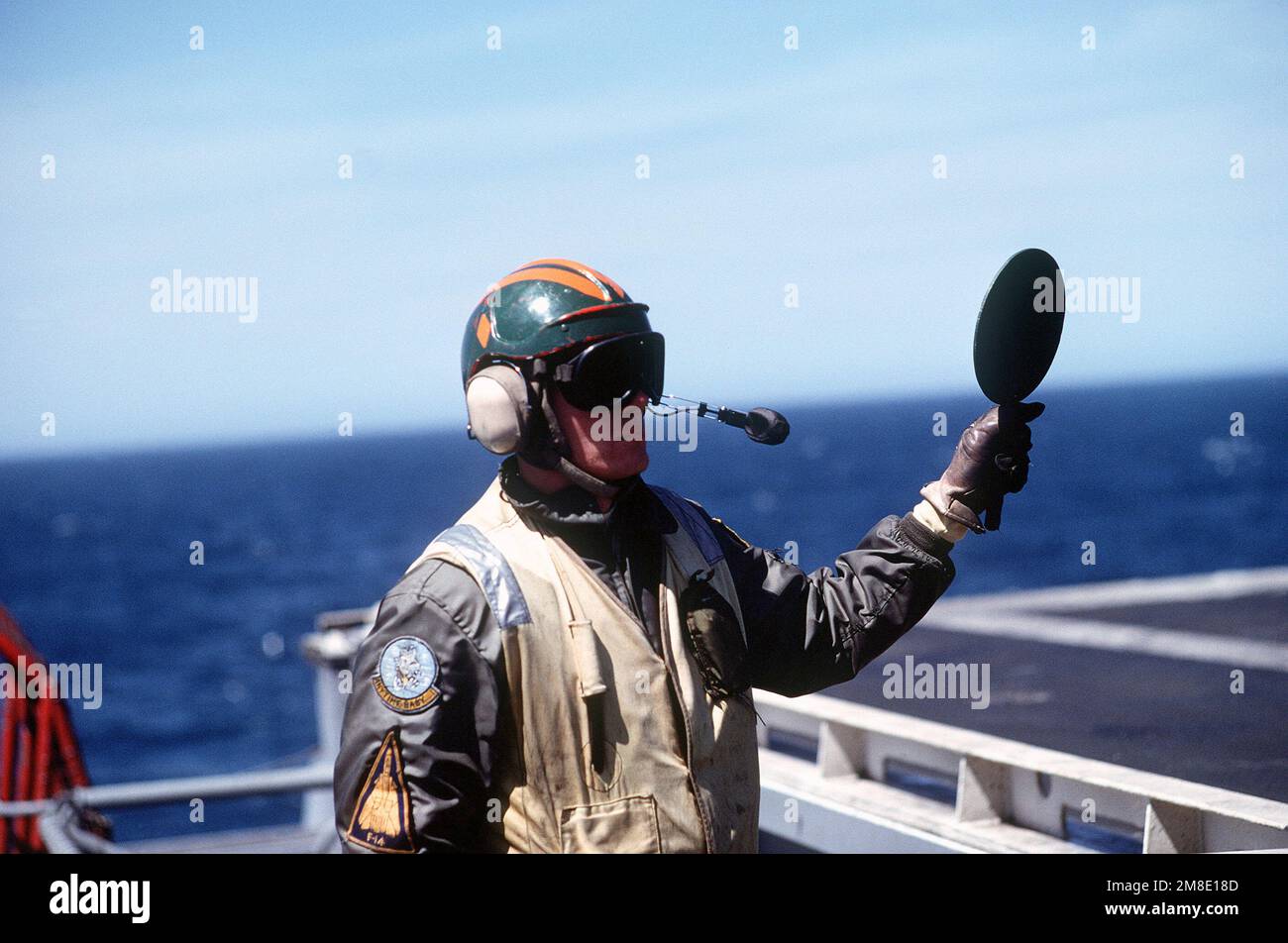 A landing signal officer (LSO) of Fighter Squadron 213 (VF-213) uses ...