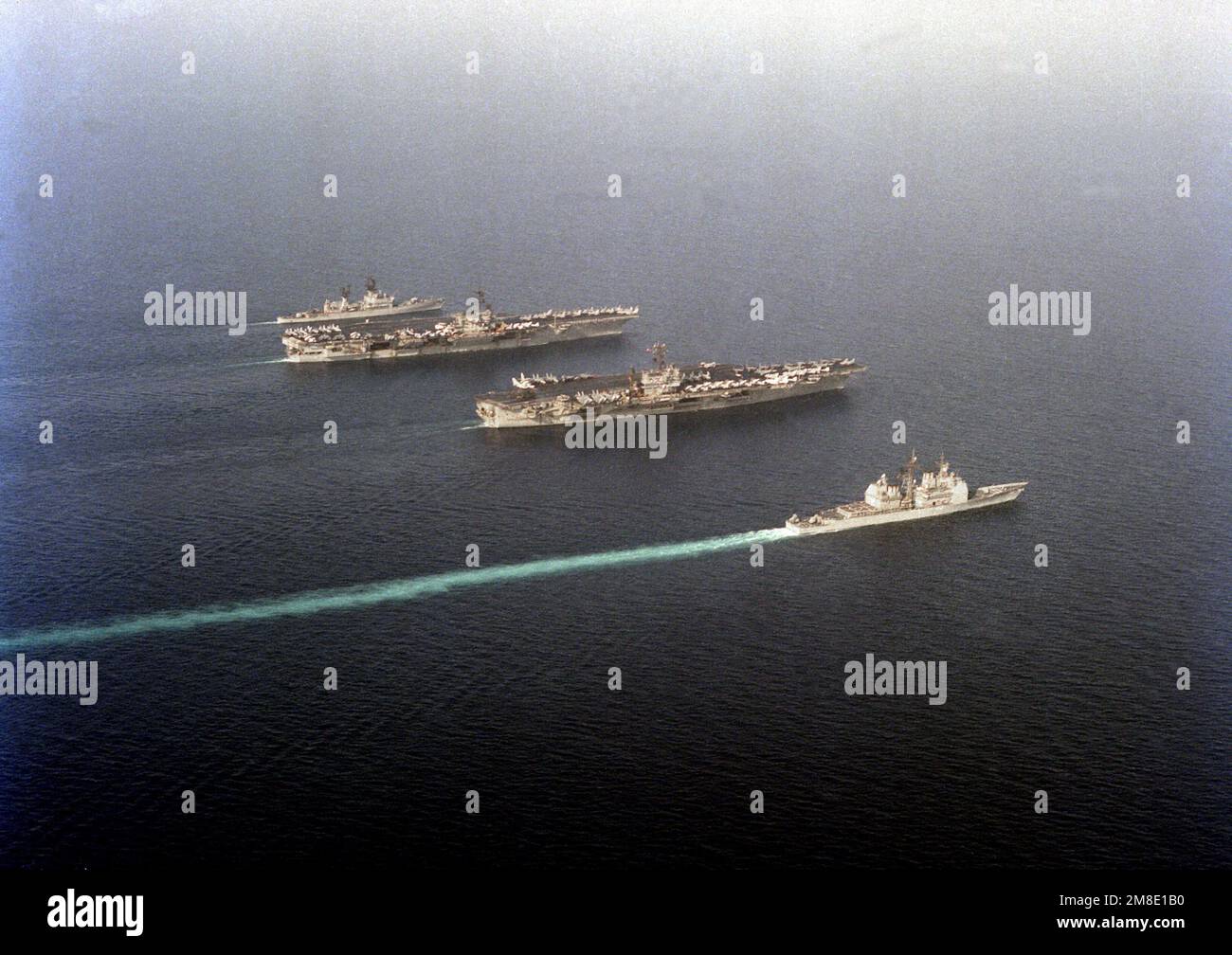 An aerial view of, from upper left, the guided missile cruiser USS ...