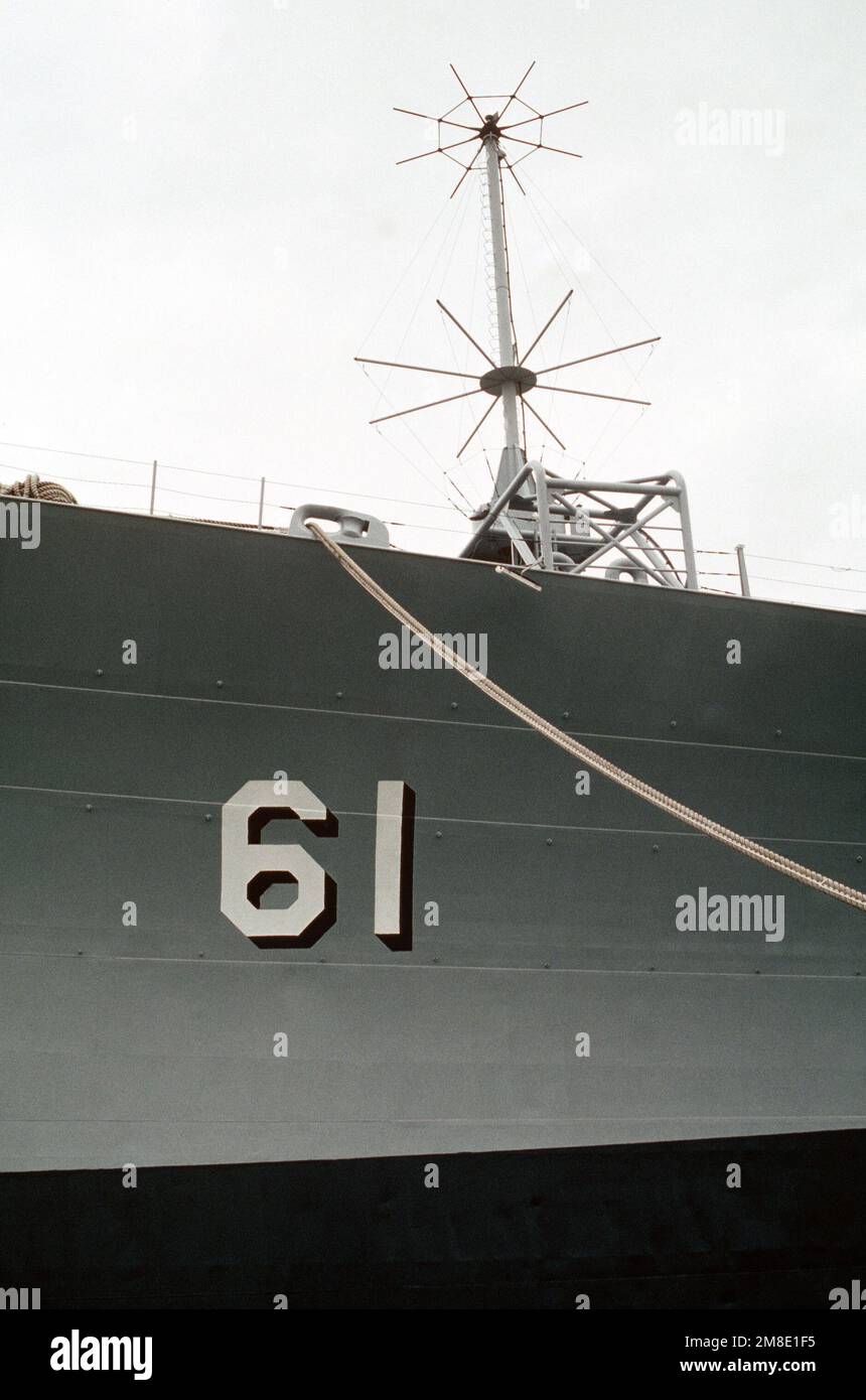 A close-up view of the ship's hull number and an antenna located near ...